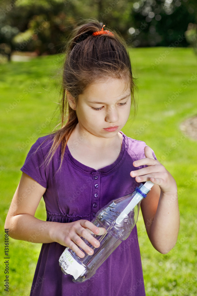 Young girl works on her Science Fair project - stuffing thermometer ...