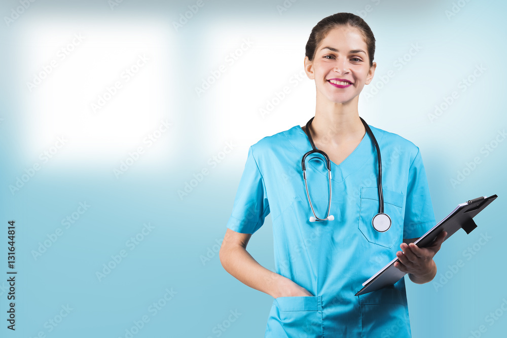beautiful woman nurse or doctor is holding a notepad board with copy ...