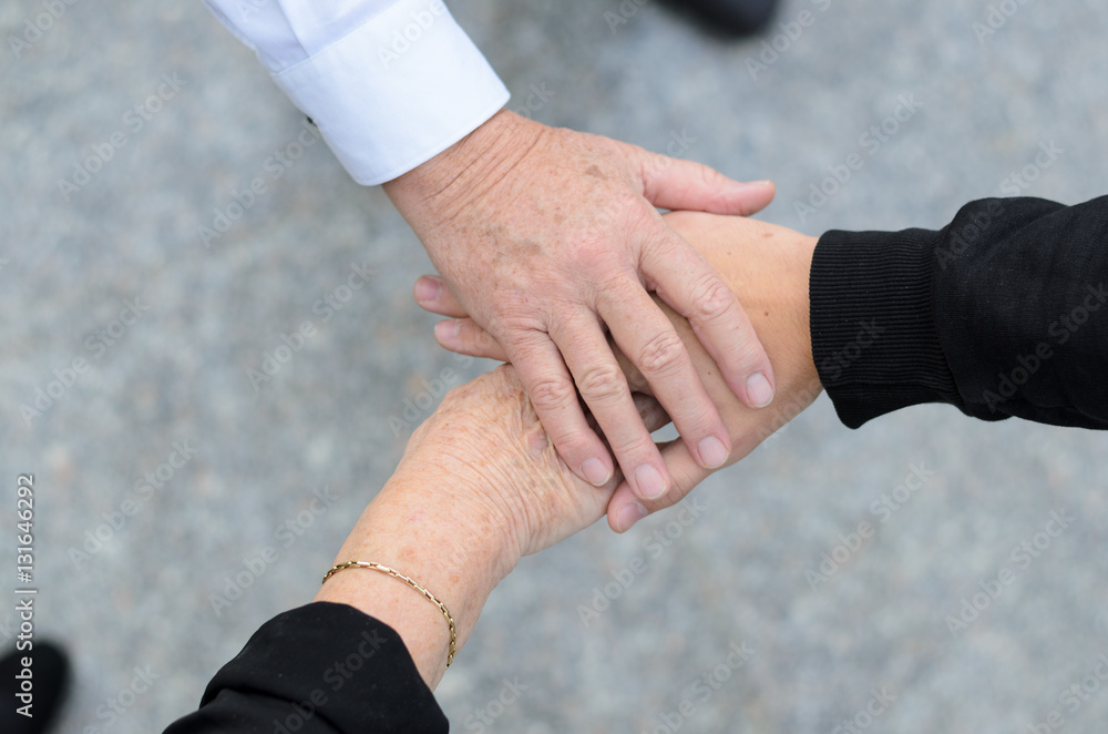 Overhead view of three hands clasped together Stock Photo | Adobe Stock