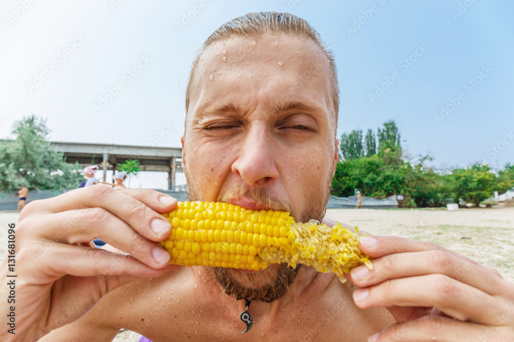 Man is eating corn Stock Photo | Adobe Stock