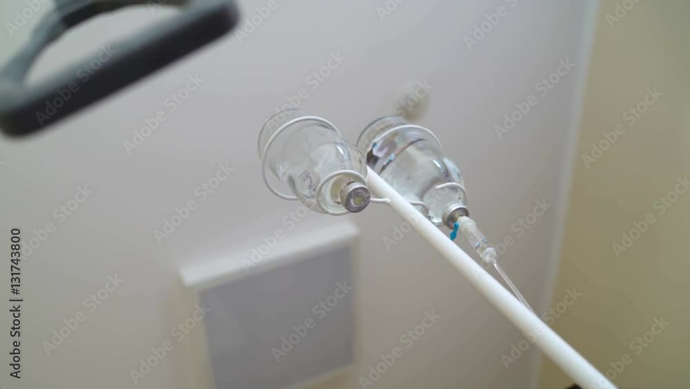 Patient POV from hospital bed. A person receiving saline solution after ...