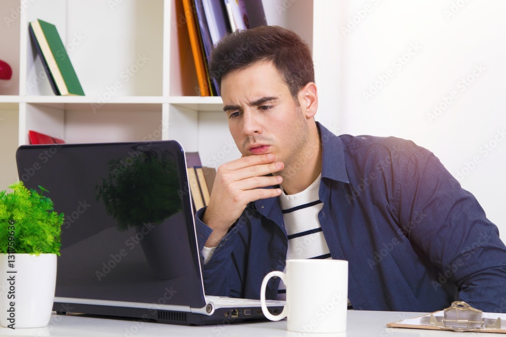 man watching the computer laptop with expression thoughtful Stock-Foto ...