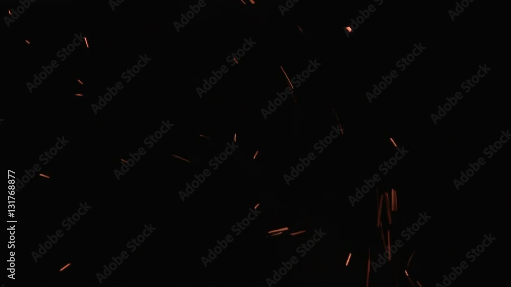 Burning ash rising from fire in the night sky, moderate amount of ...