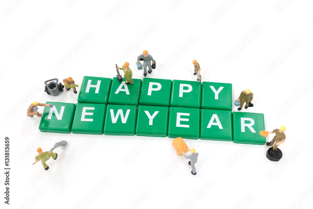 Miniature worker team building word happy new year on white background ...