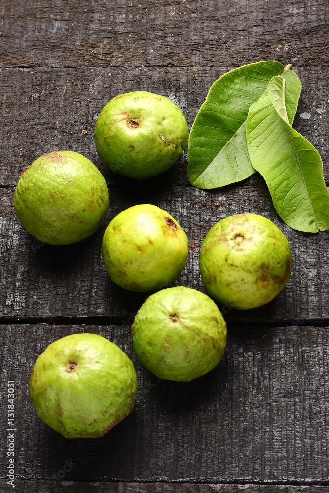 whole fresh Guava with stem leaves on black background Stock Photo ...