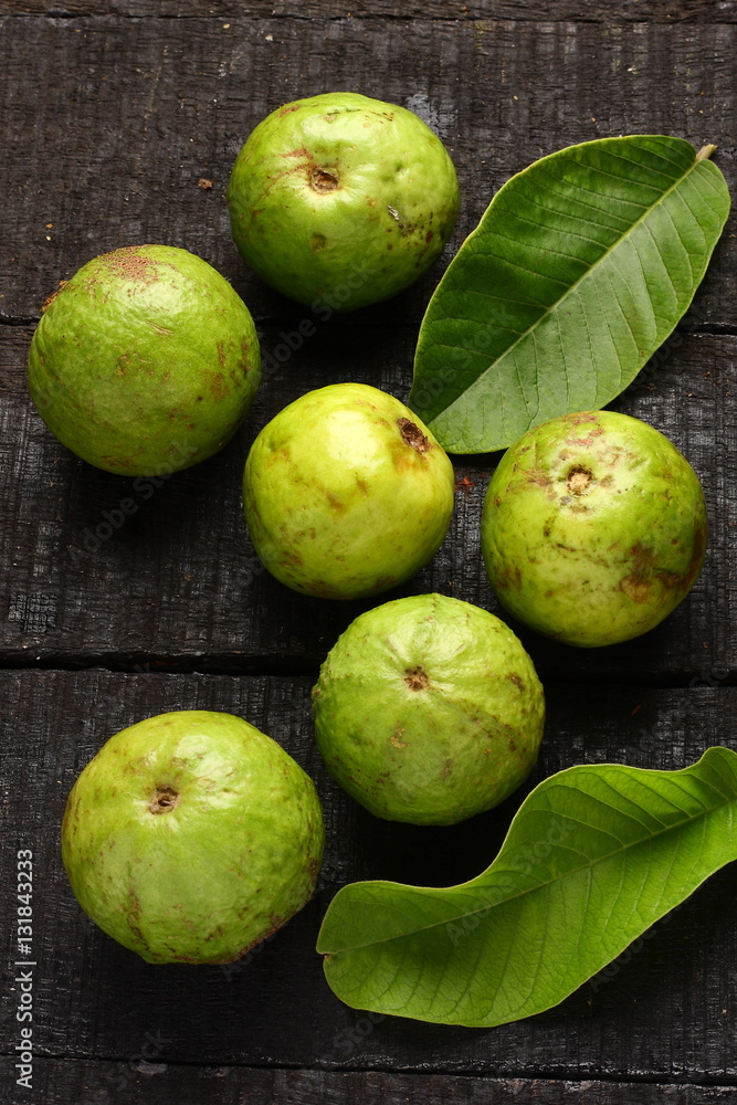 whole fresh Guava with stem leaves on black background Stock Photo ...