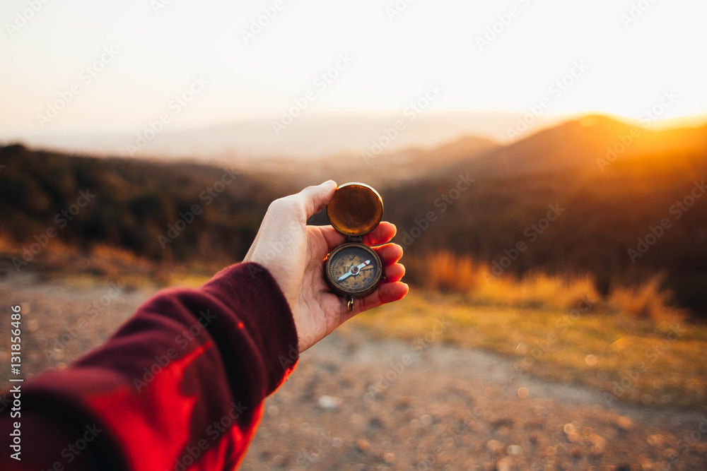 Hand of person holding compass Stock Photo | Adobe Stock