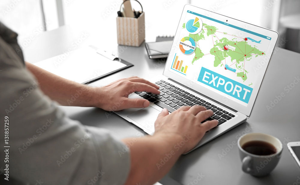 Logistics concept. Man with laptop. Word EXPORT and world map on screen ...