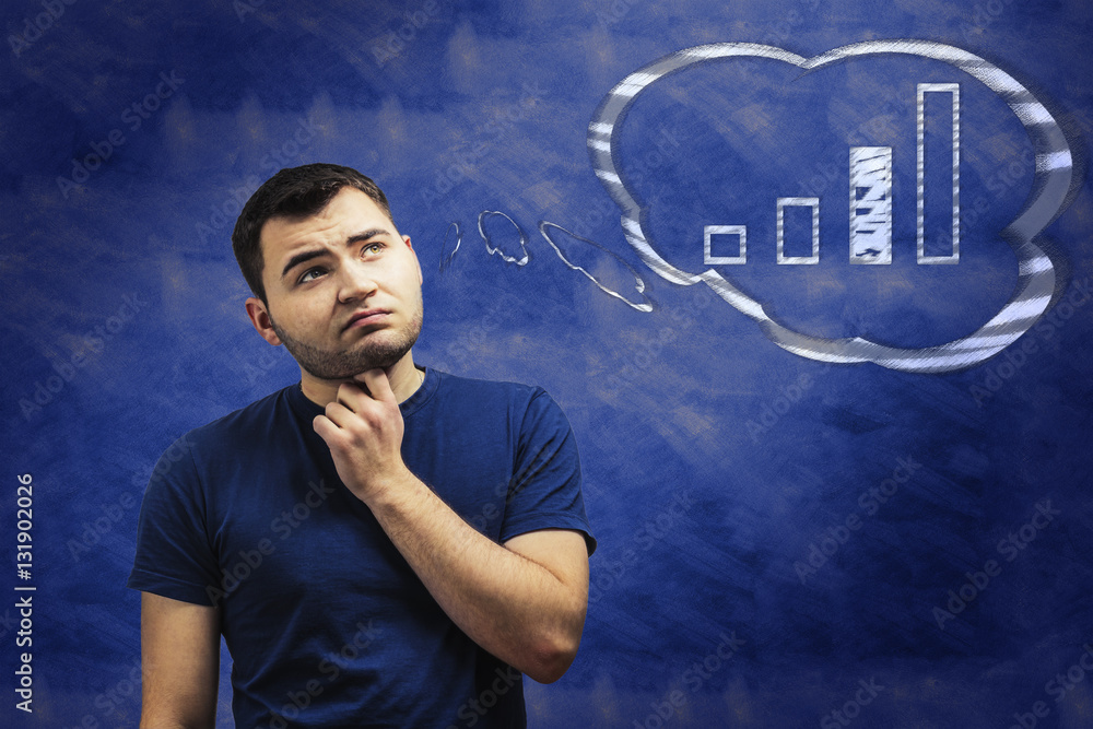 Mann denkt an Diagramme Stock-Foto | Adobe Stock