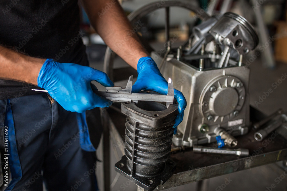 Mechanic fixing a compressor engine Stock Photo | Adobe Stock