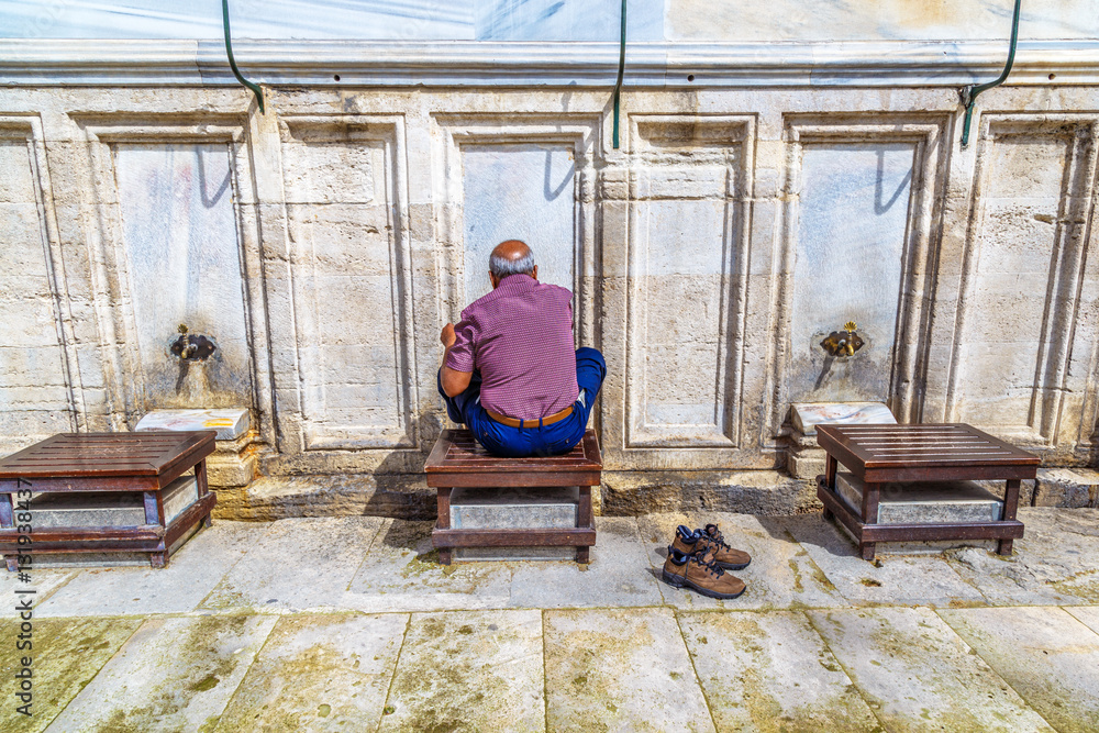 Muslim male and the traditional ritual washing legs and hands before ...