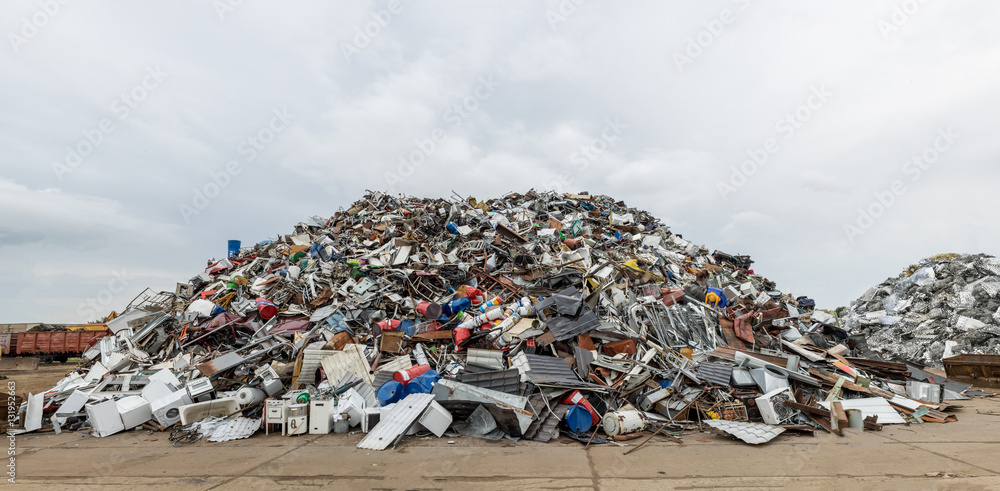 Dumping ground. Scrap metal heap. Compressed crushed cars is returned ...