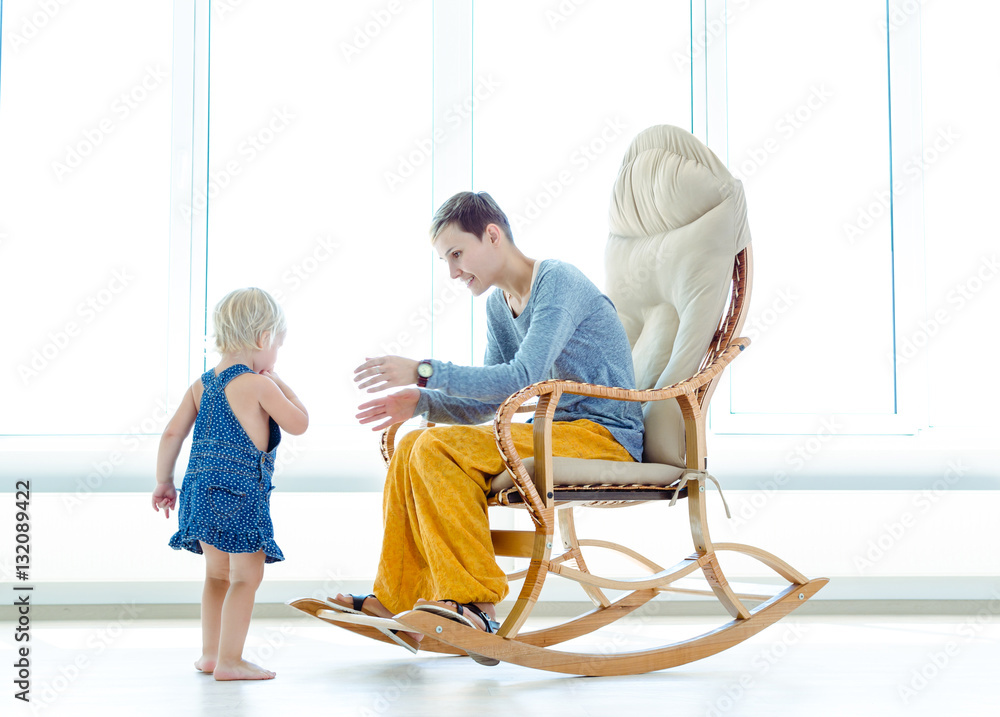 Mother and daughter sitting in a rocking chair Stock-Foto | Adobe Stock