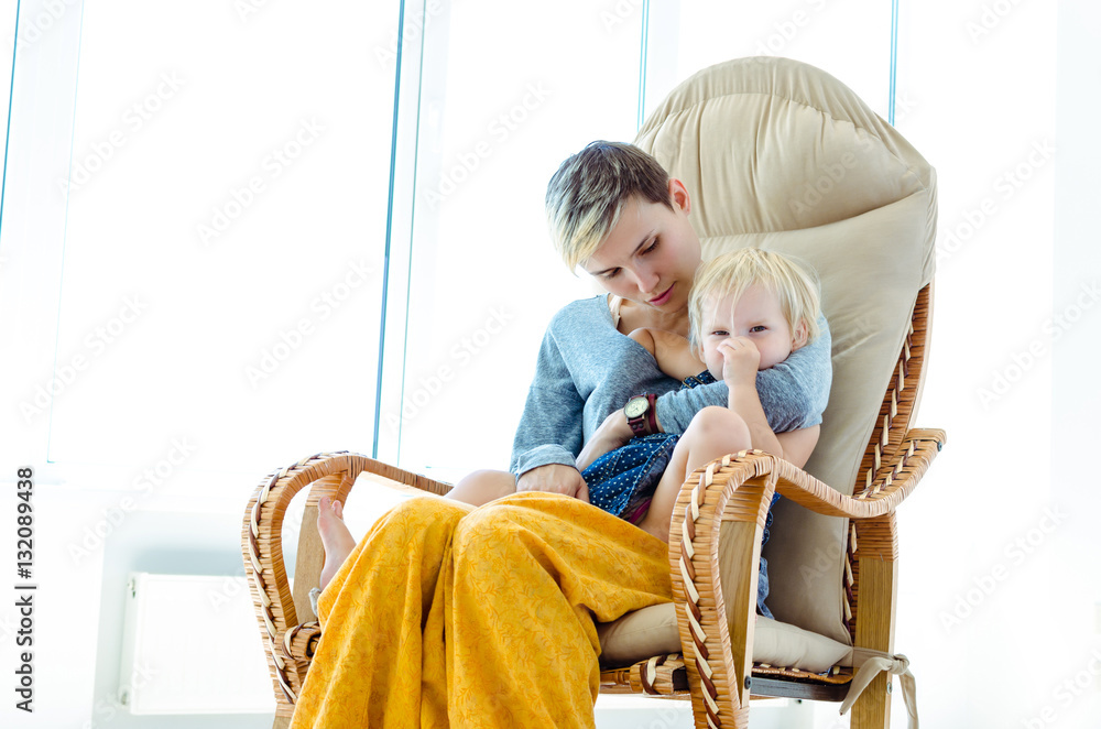 Mother and daughter sitting in a rocking chair Stock-Foto | Adobe Stock