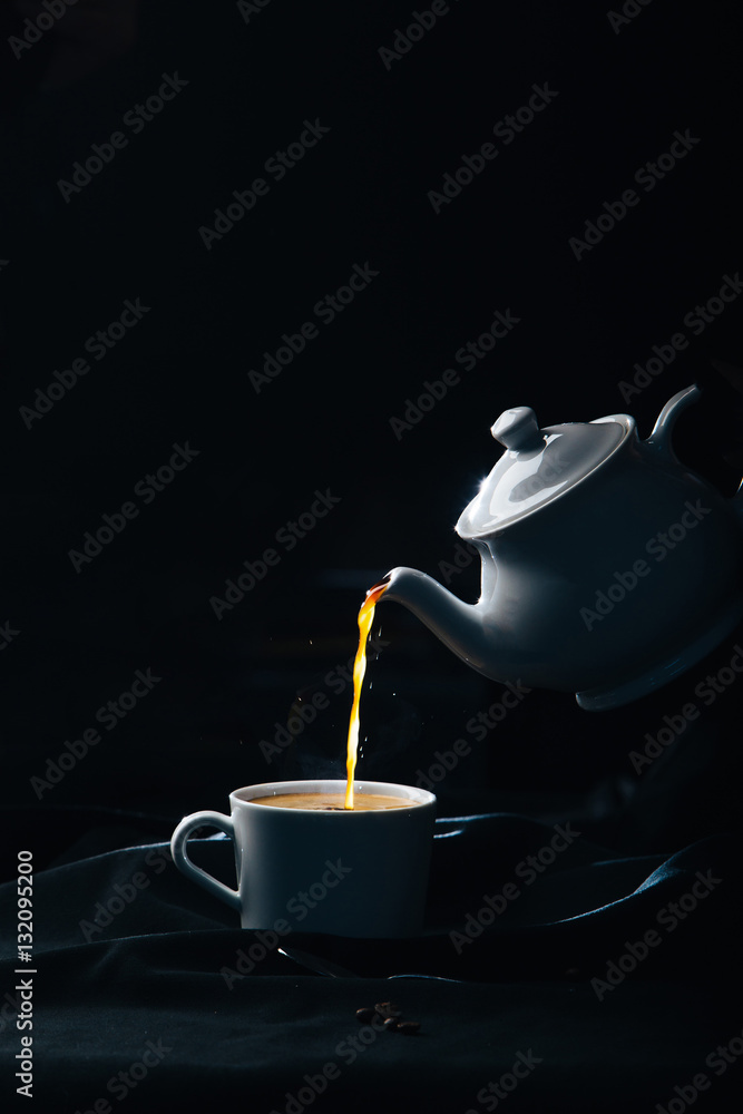 Pouring tea into a cup Stock Photo | Adobe Stock