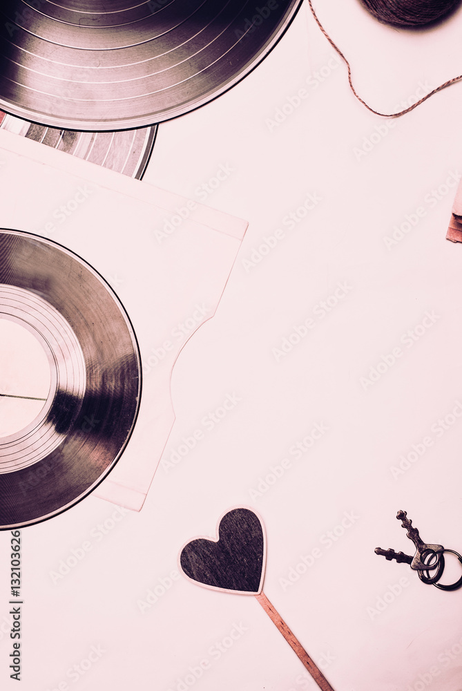 Stack of scratched dusty old vinyl records tied with rope on white ...