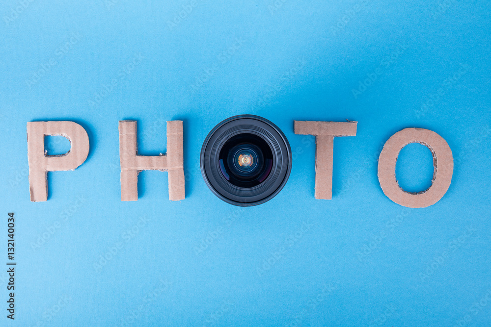 Word PHOTO made from cardboard letters on a blue background made photo ...