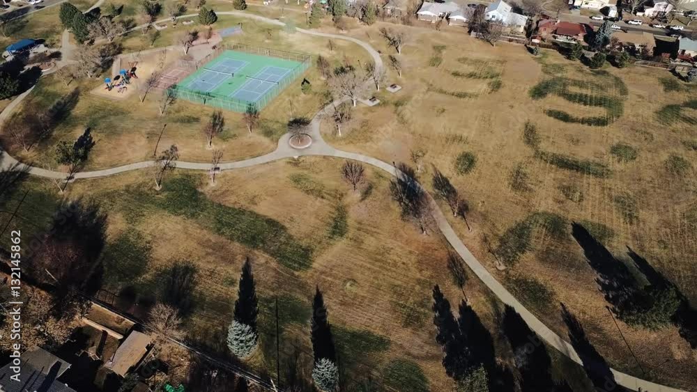 long and curved path divides to encircle recreation area between two ...