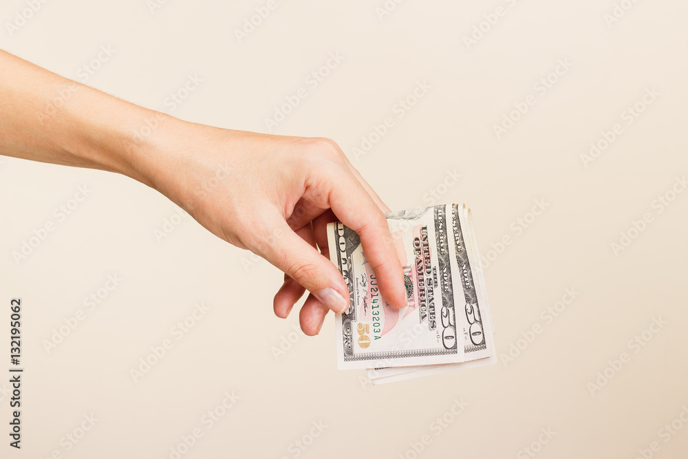 Woman's hand with money on a light background Stock Photo | Adobe Stock