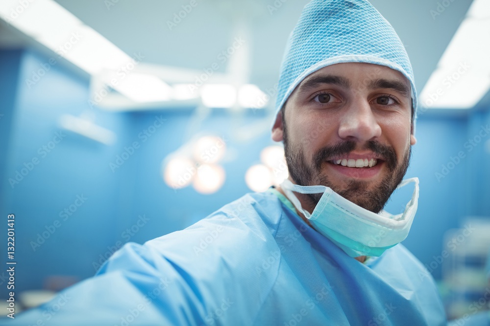 Portrait of male surgeon smiling in operation theater Stock Photo ...