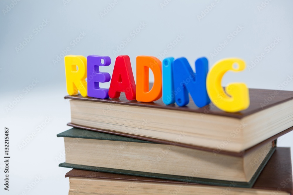 Reading letter blocks on stack of books Stock Photo | Adobe Stock