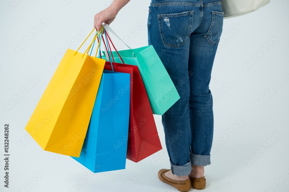 Woman carrying colorful shopping bags Stock Photo | Adobe Stock