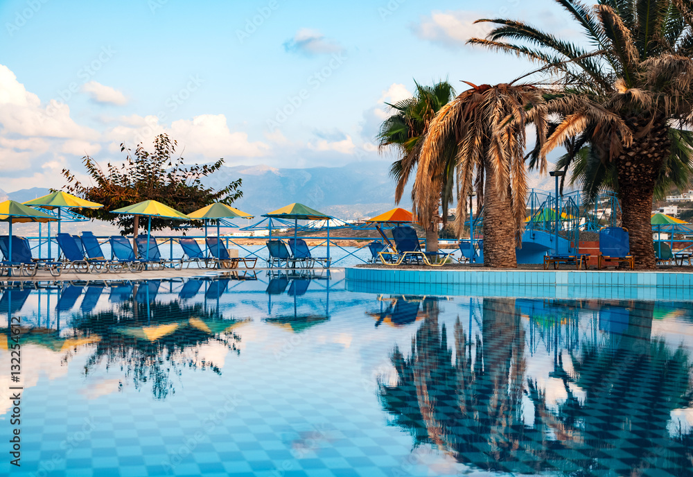 Nice view on the swimming pool with palm trees on the shore of the ...