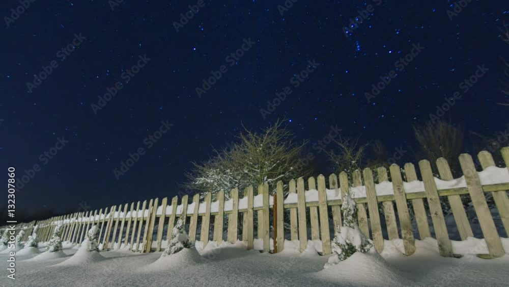 Night sky stars time lapse, wooden fence foreground in house backyard ...