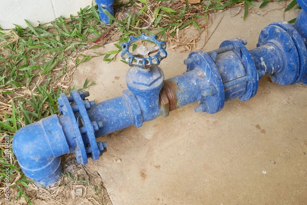 Blue gate valve and pipe line on the underground concrete water tank ...