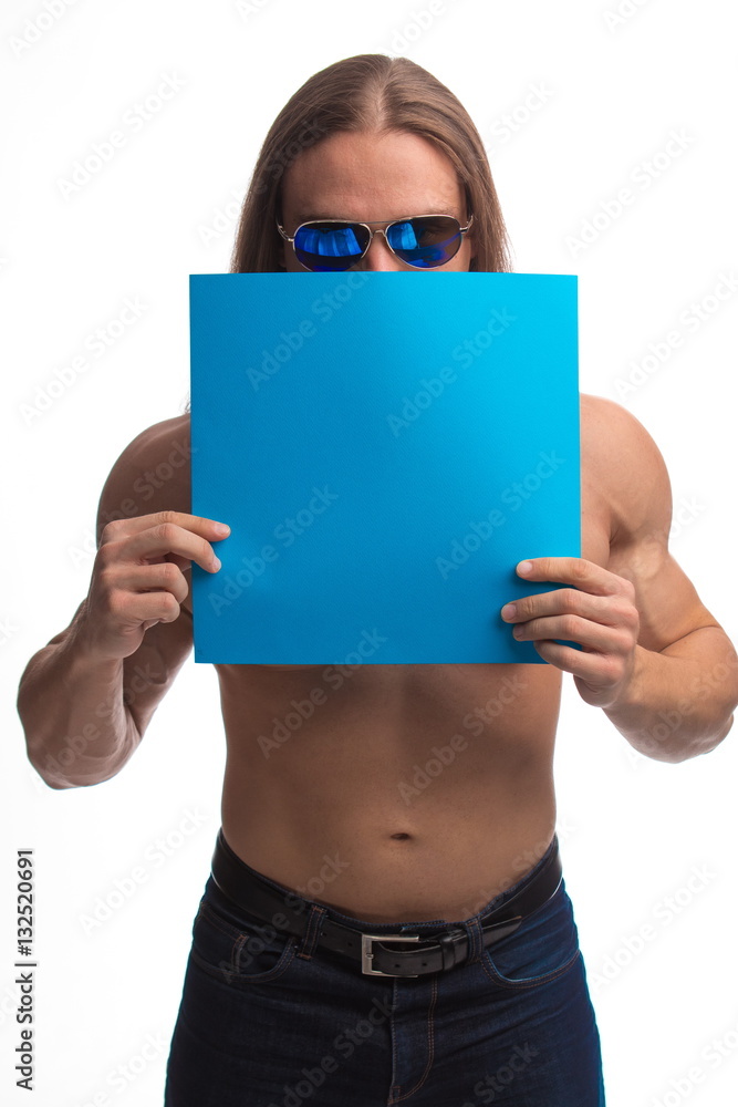 Portrait of a brutal man bodybuilder athlete with long hair with a ...