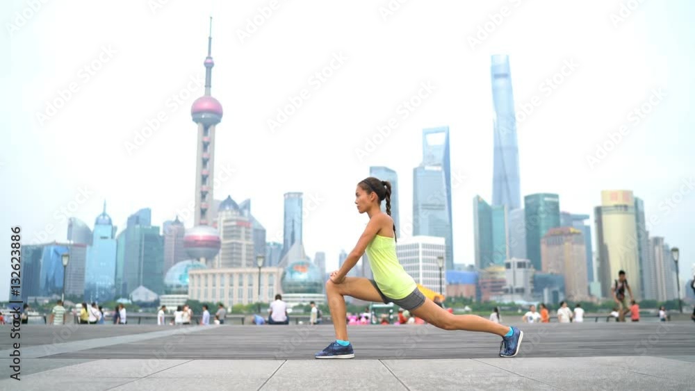 Runner stretching legs after workout in Shanghai, China on famous ...