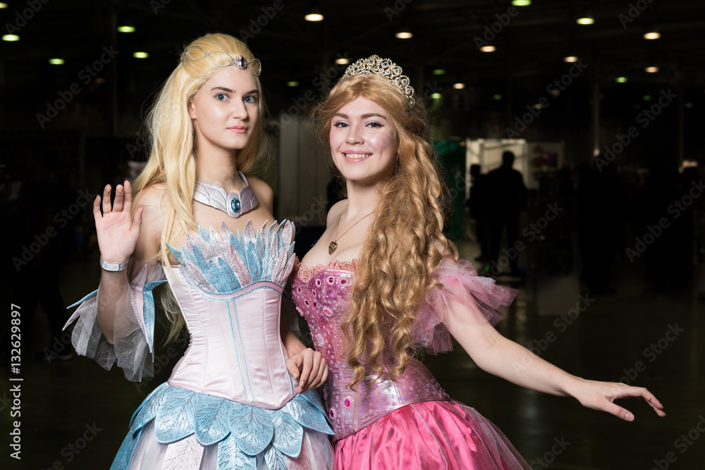 Poster Two young woman cosplayer wearing beautiful dresses posing ...