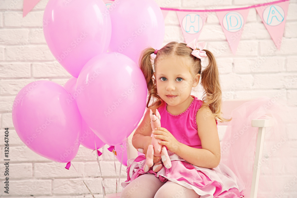 Little cute girl with party decor on brick wall background Stock Photo ...
