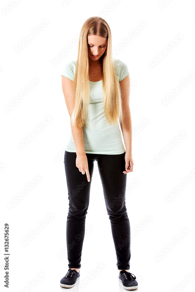 Young student woman pointing down. foto de Stock | Adobe Stock