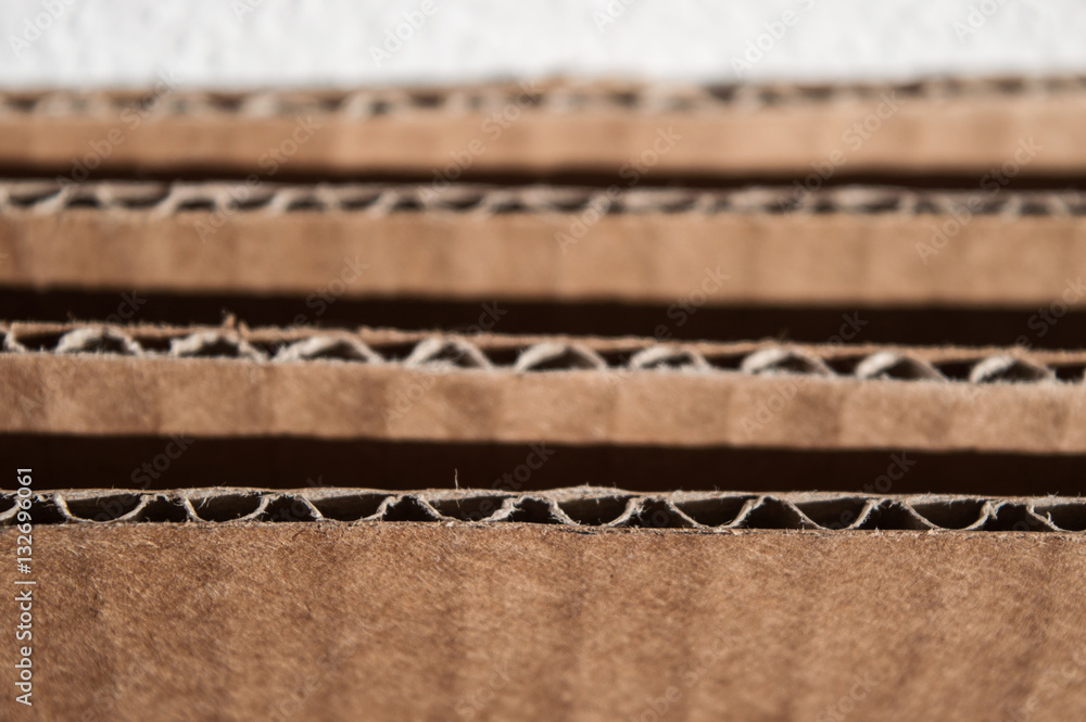 Texture of layered brown cardboard side. Folded cardboard boxes against ...