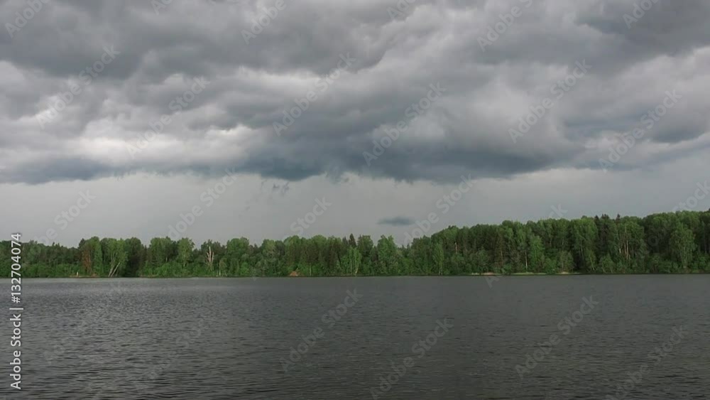 Gray storm clouds float over the lake. Rain on the river. The storm on ...