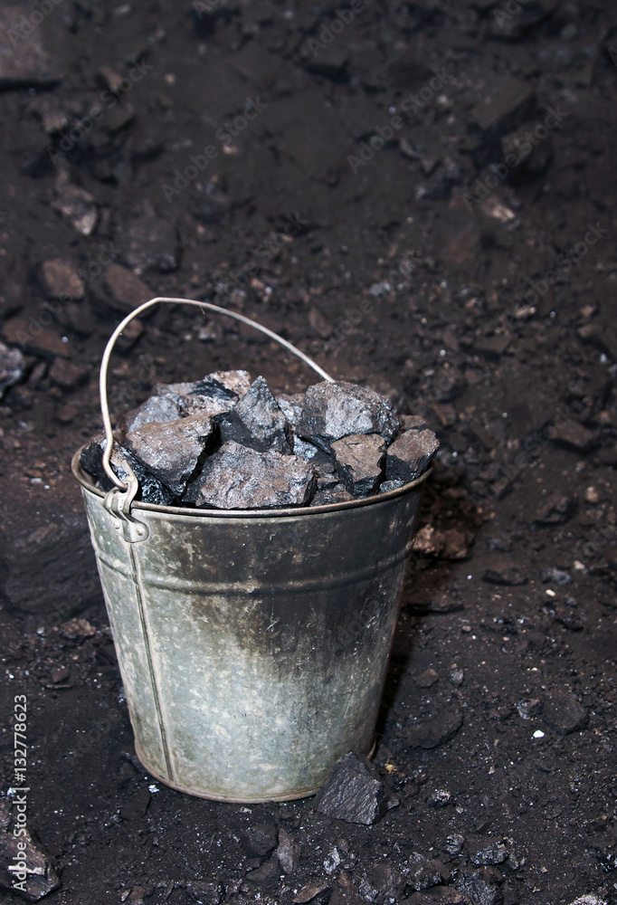 Metal bucket full of lumps of coal Stock Photo | Adobe Stock