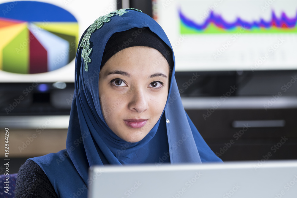 Young woman wearing a hijab working at a computer, close up shot Stock ...