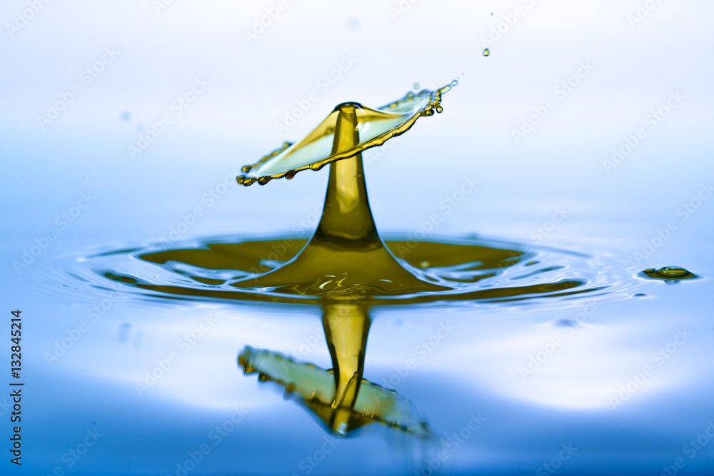 Water drop falling and drips on water mirror. Water drop splash and ...