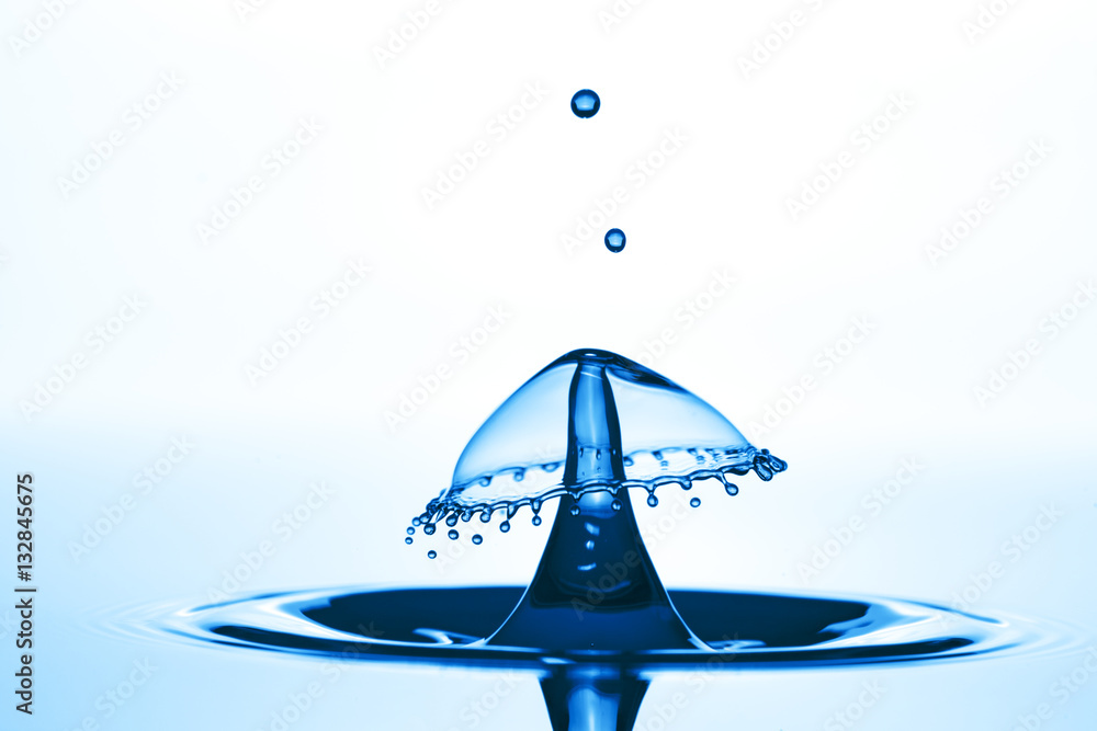 Water drop falling and drips on water mirror. Water drop splash and ...