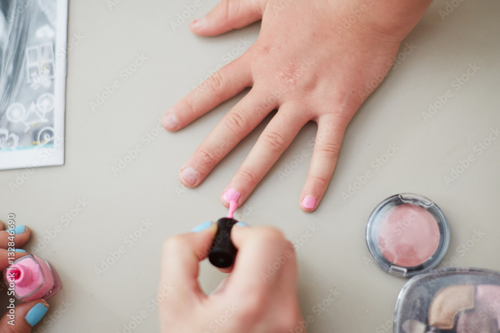 young girl on a manicure. paint nails Stock Photo | Adobe Stock