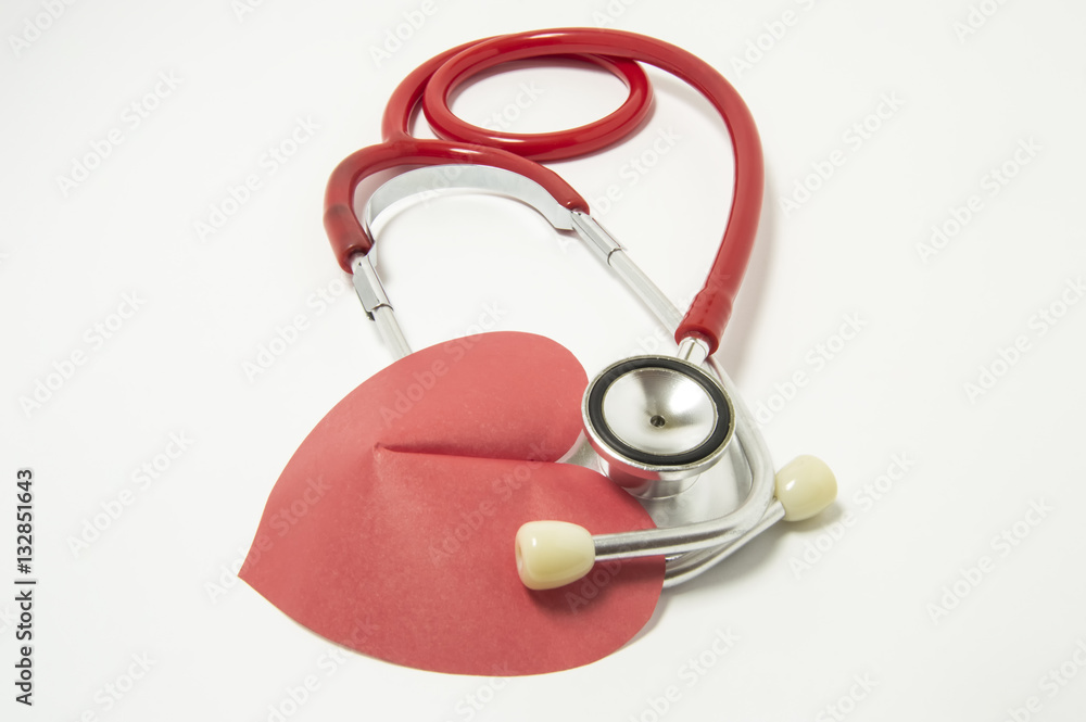 Red stethoscope chestpiece lying to red heart shape on white background ...
