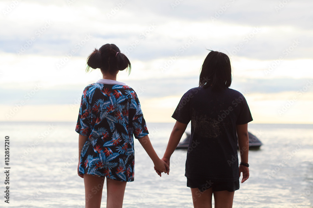 Two Best Friends Holding Hands On The Beach