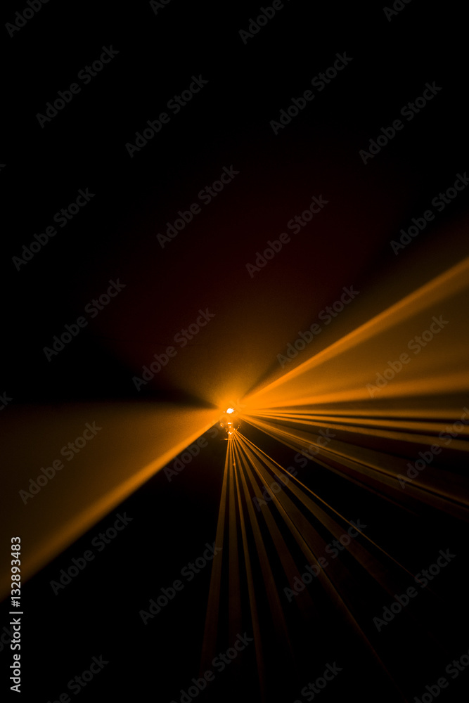 Laser beam orange on a black background Stock-Foto | Adobe Stock