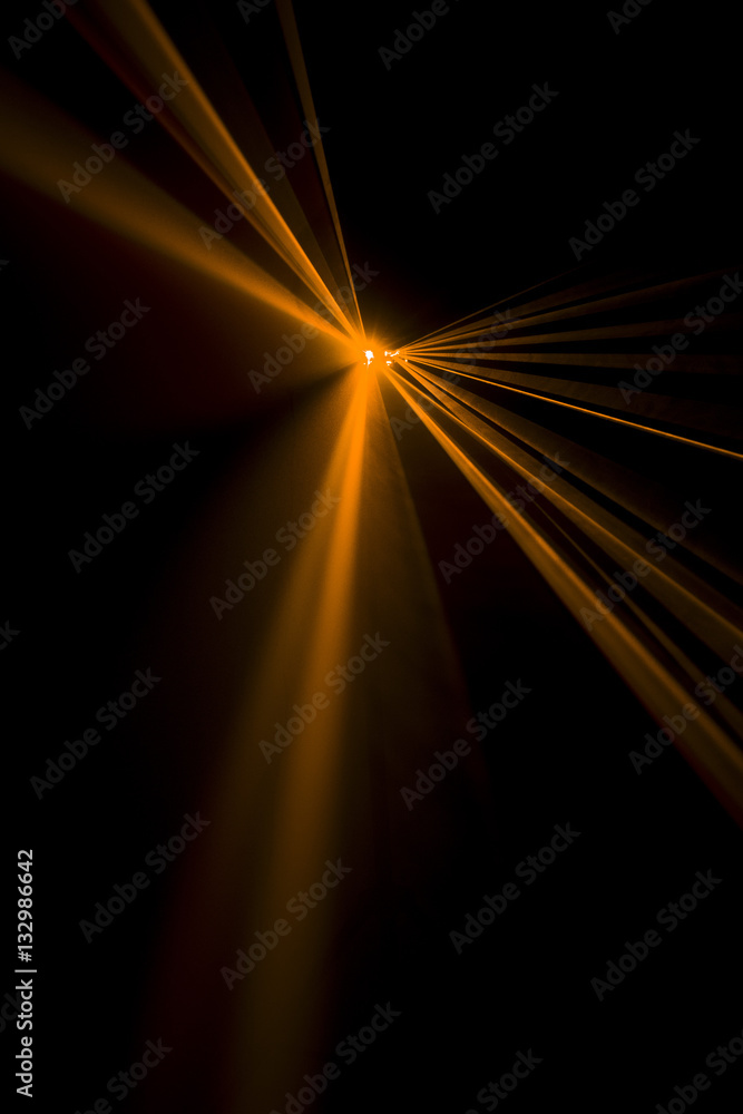 Laser beam orange on a black background Stock Photo | Adobe Stock
