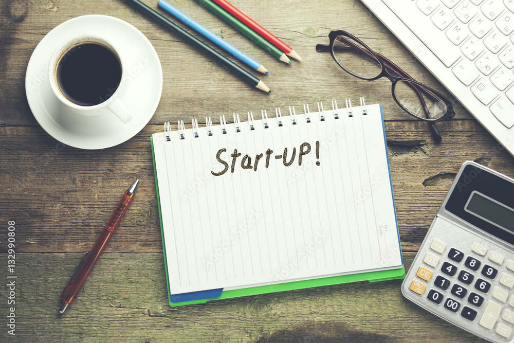 Start-up text on notebook with coffee and keyboard on table Stock-Foto ...