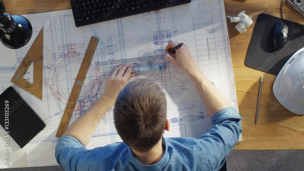 Top View of a Technical Engineer Working on His Blueprints, Drawing on ...
