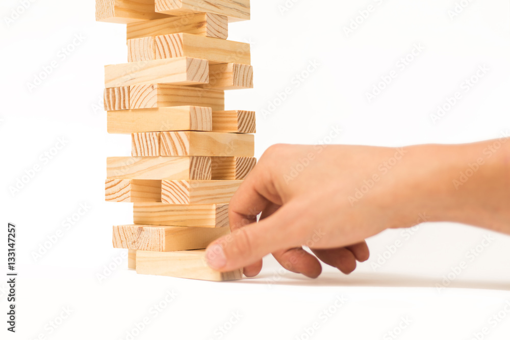 Tower of wooden blocks Jenga game and man's hand Stock Photo | Adobe Stock