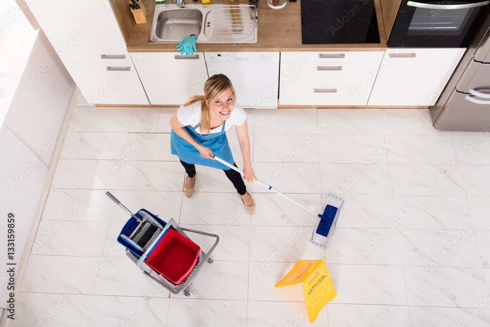 Woman Cleaning Kitchen Floor With Mop Stock-Foto | Adobe Stock