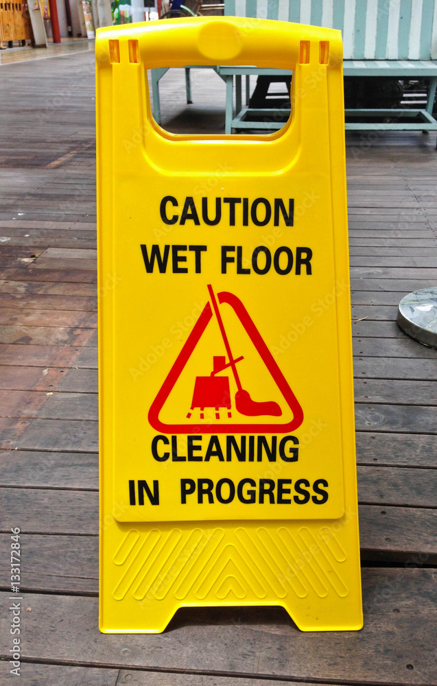 caution wet floor sign cleaning in progress sign on wood floor Stock ...